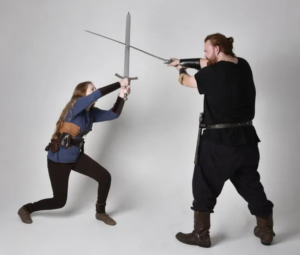 People Fighting In War With Swords