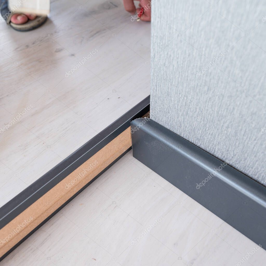 The plinth is dark gray to match the color of the door, mounting the ...