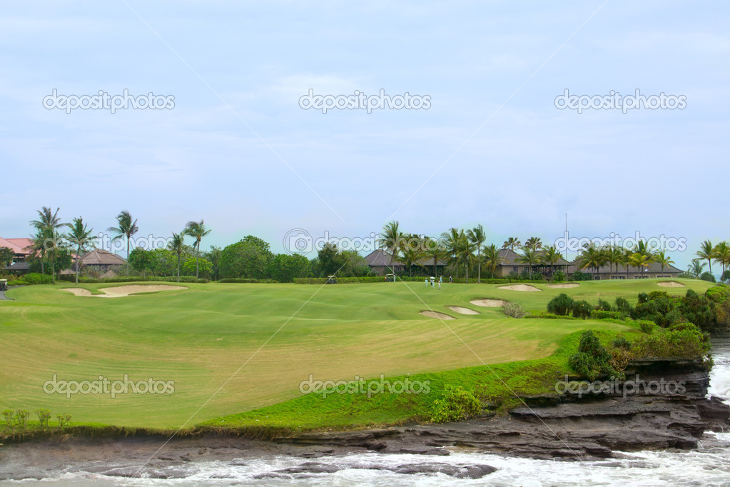 Golf course. Green field and blue sky Stock Photo by ©Gemmy 25070181