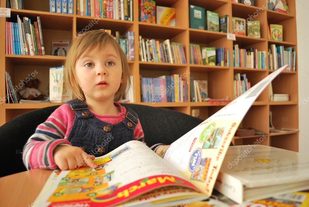 Girl reading in a library — Stock Photo © Malija #13644883