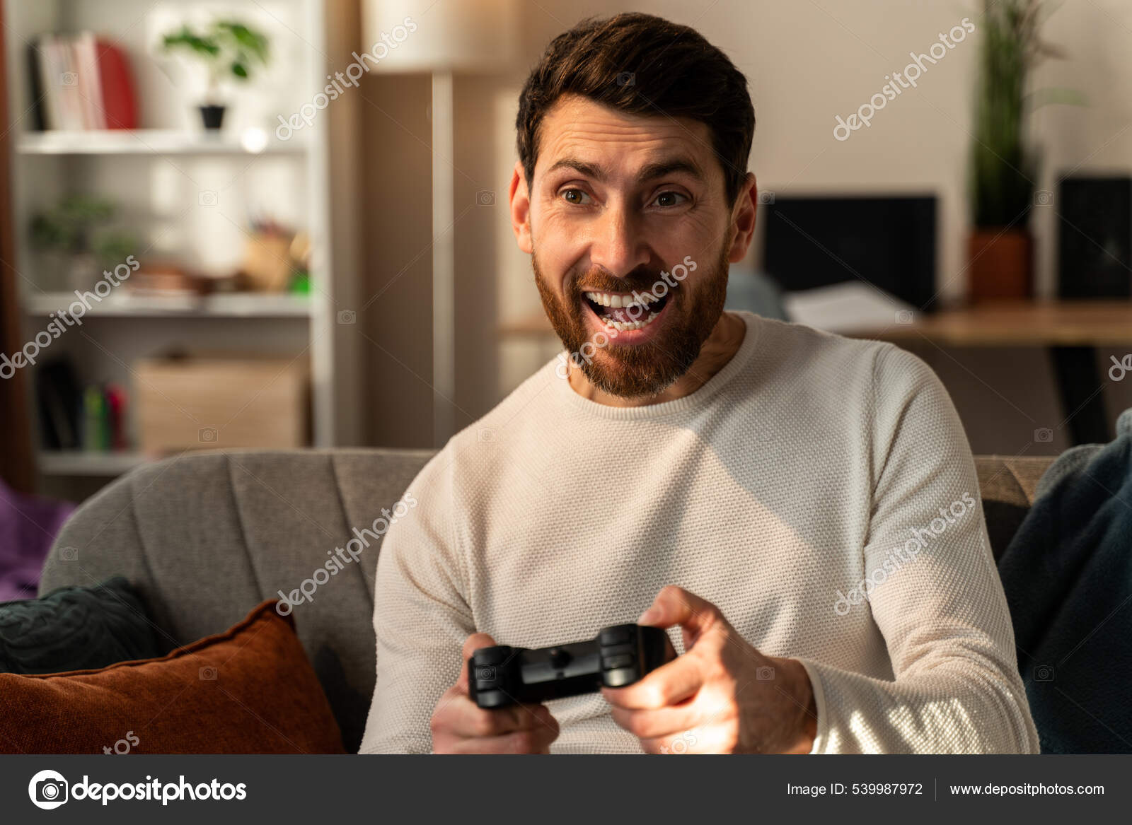 Excited Young Man Playing Video Games Making Winner Gesture While ...