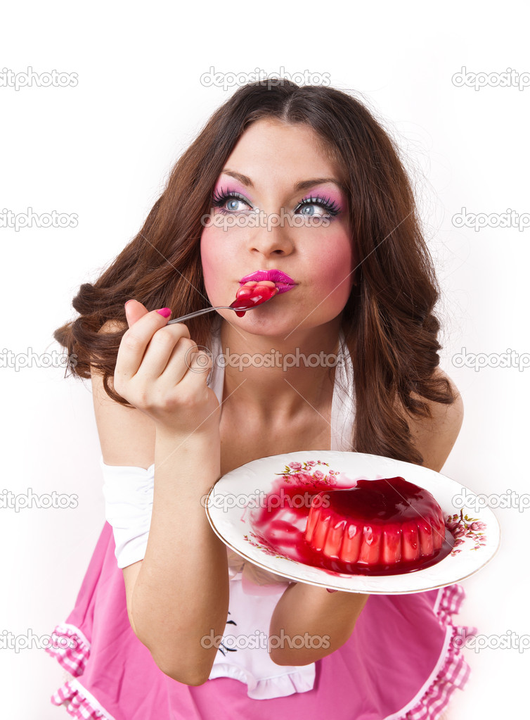 Attractive young satisfied woman eating pudding isolated on white ...