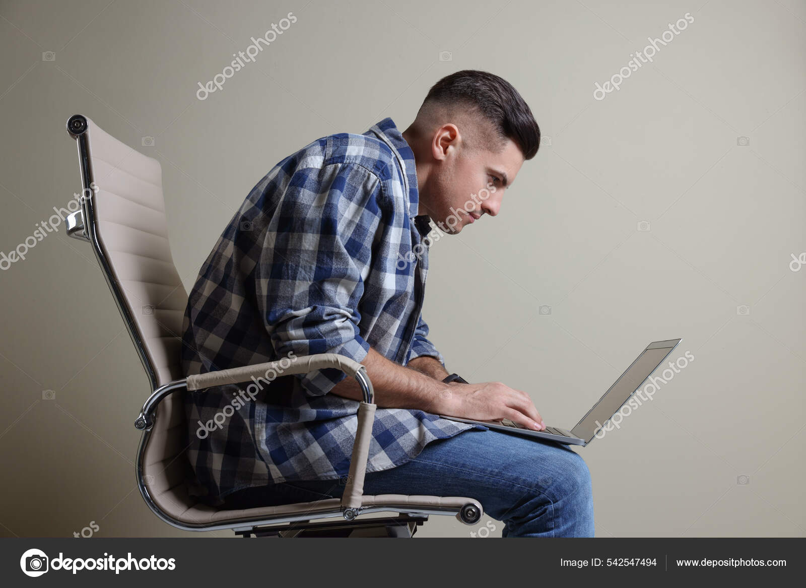 Man Poor Posture Using Laptop While Sitting Chair Grey Background ...