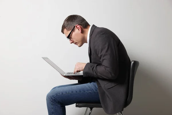 Man Poor Posture Using Laptop While Sitting Chair Grey Background ...