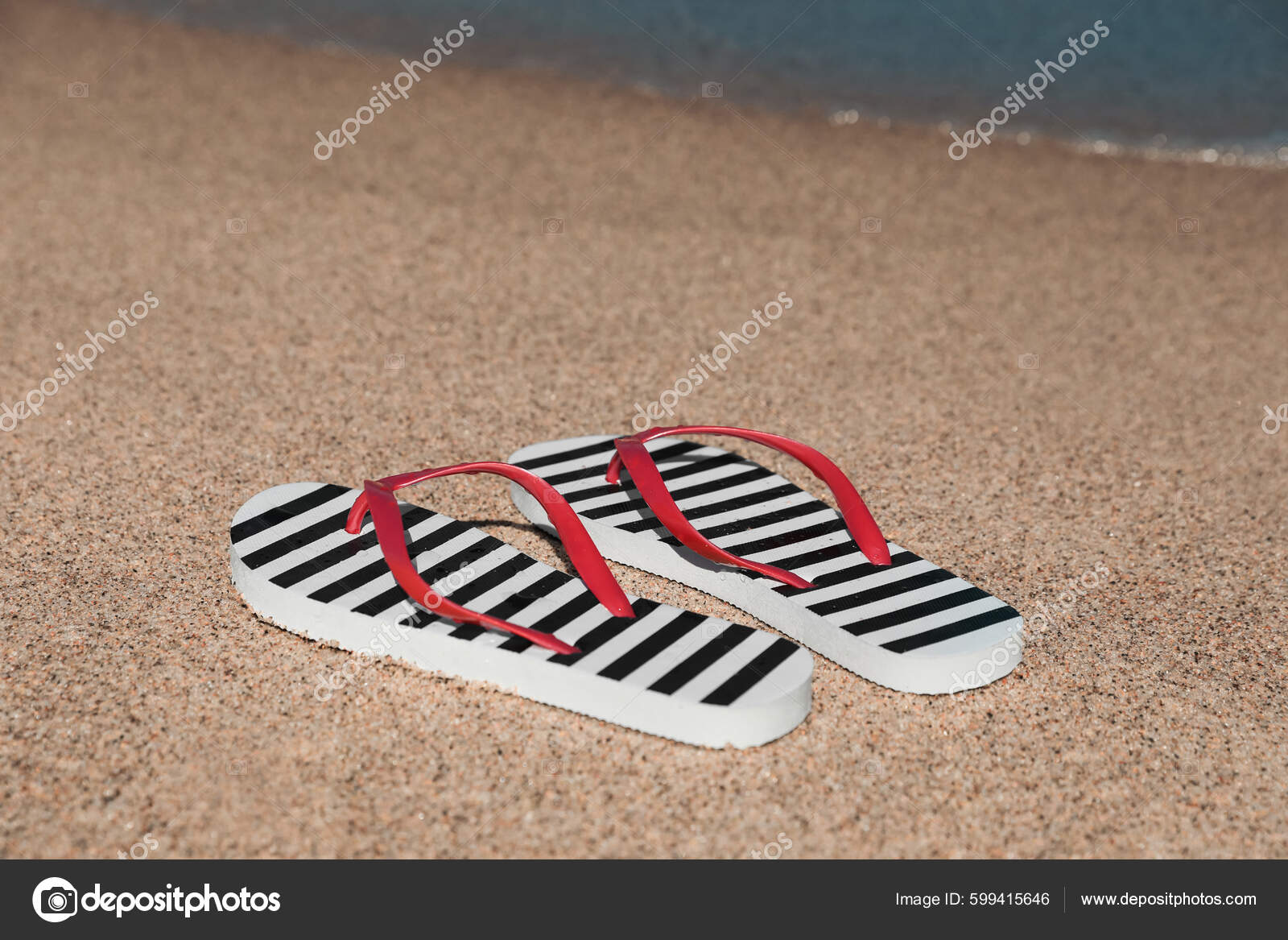 Striped Flip Flops Sandy Beach Sea — Stock Photo © NewAfrica #599415646