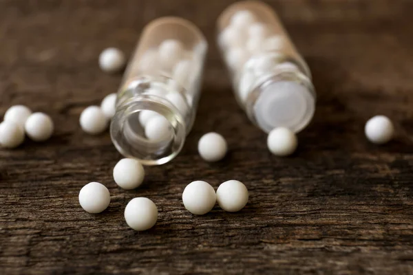 Bottles of homeopathic remedy on the wooden table, closeup - Stock ...