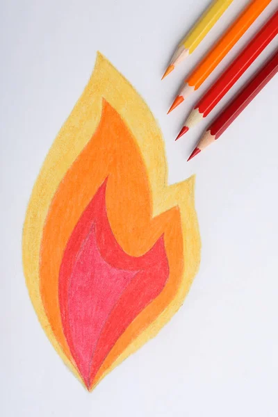 Drawing of fire and colorful pencils on white background, top view ...