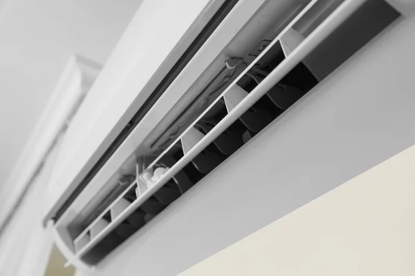 Modern air conditioner on white wall indoors, closeup view - Stock ...