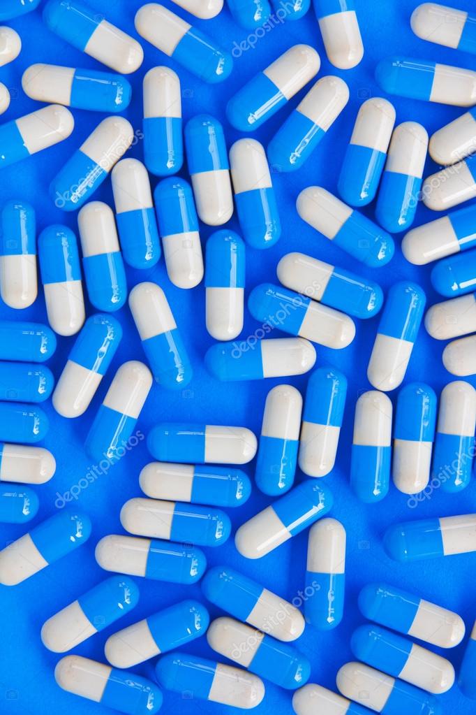 Capsule pills background Stock Photo by ©ponsulak 34261497