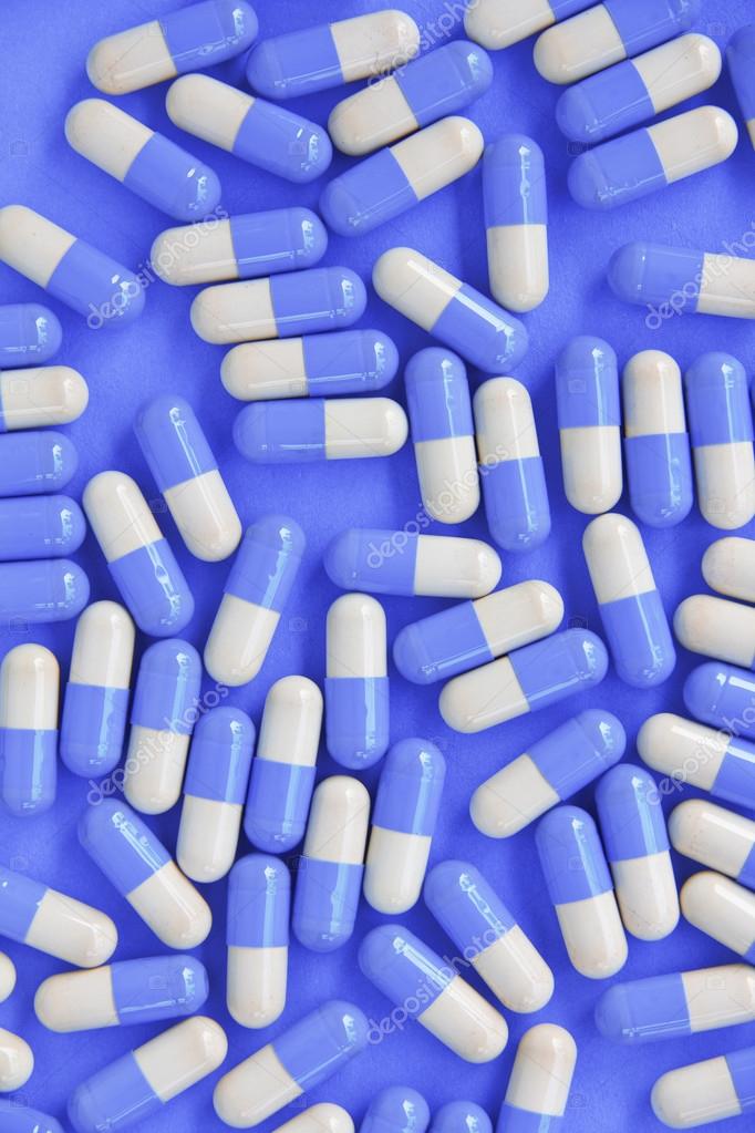 Capsule pills background Stock Photo by ©ponsulak 34261759