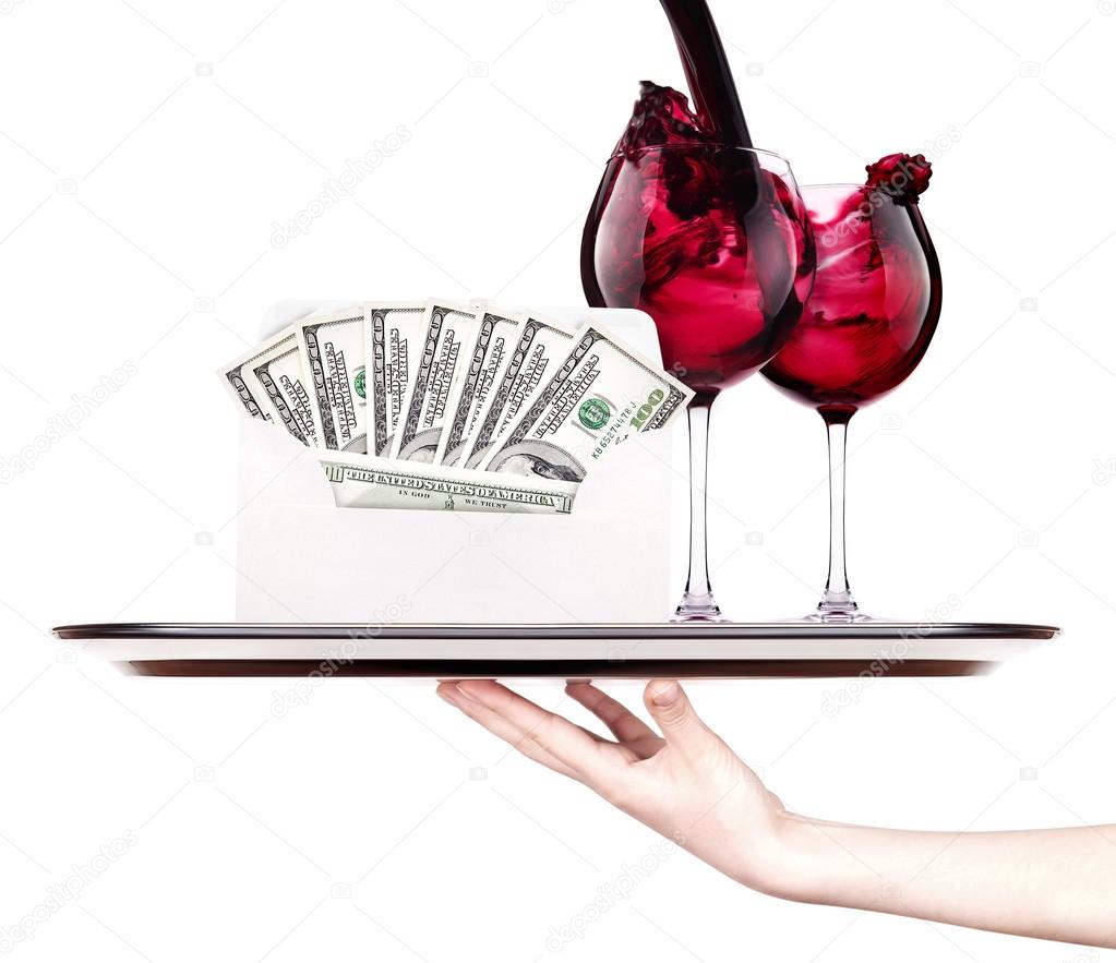 Money in envelope on a tray with wine and hand Stock Photo by ...