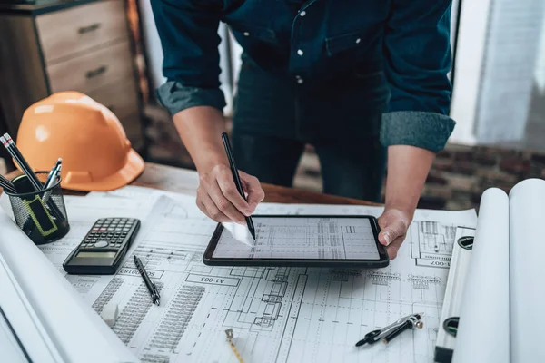 Engineering working with drawings inspection on tablet in the office ...