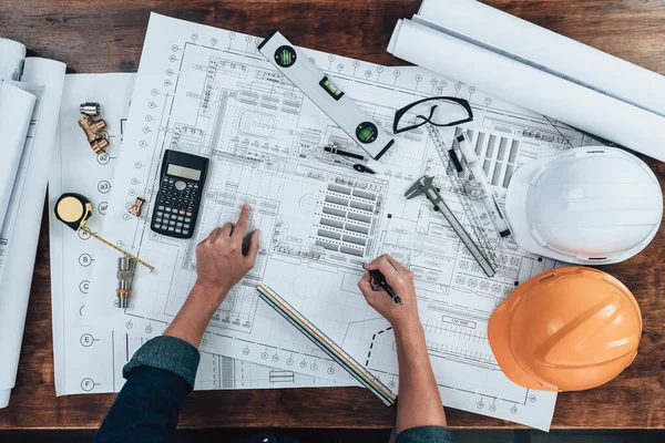 Top view Engineering working with drawings inspection and writing on ...