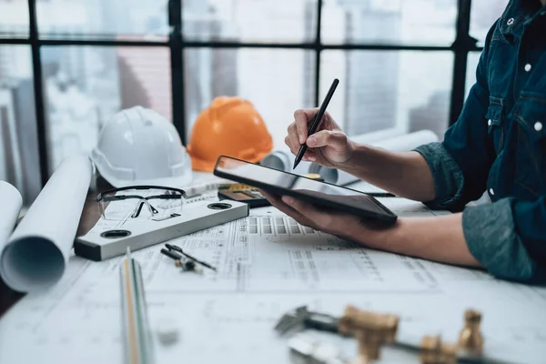 Engineering working with drawings inspection on tablet in the office ...