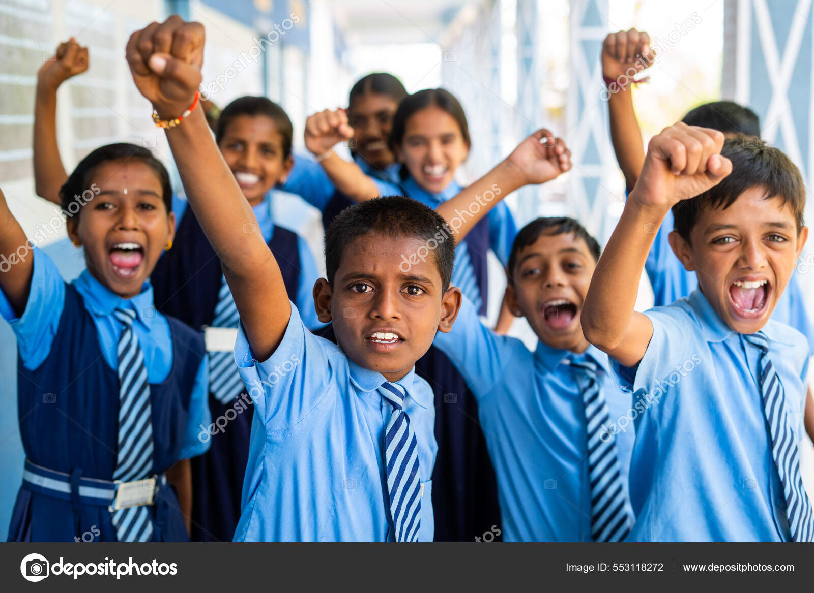 Group of cheerful students shouting by looking camera at school ...