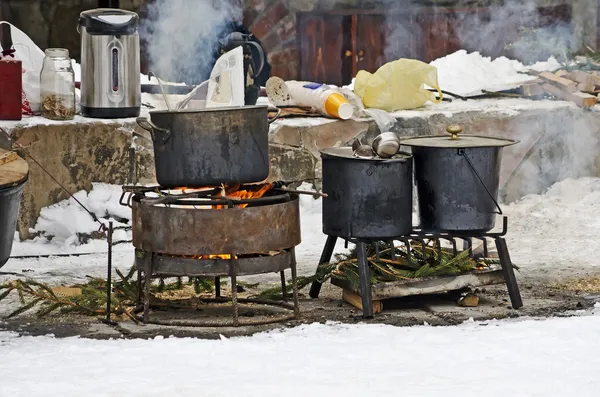 Large pots for cooking over an open fire outdoors in the winter - Stock ...