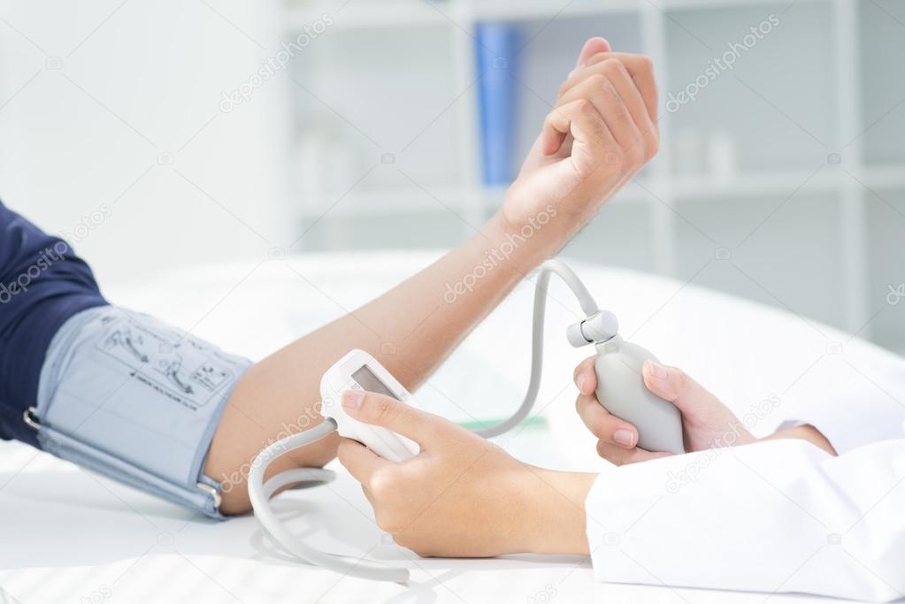 Checking blood pressure — Stock Photo © DragonImages #17139927
