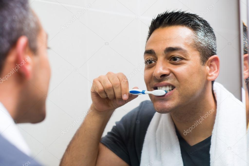 Man brushing teeth — Stock Photo © DragonImages #41732233