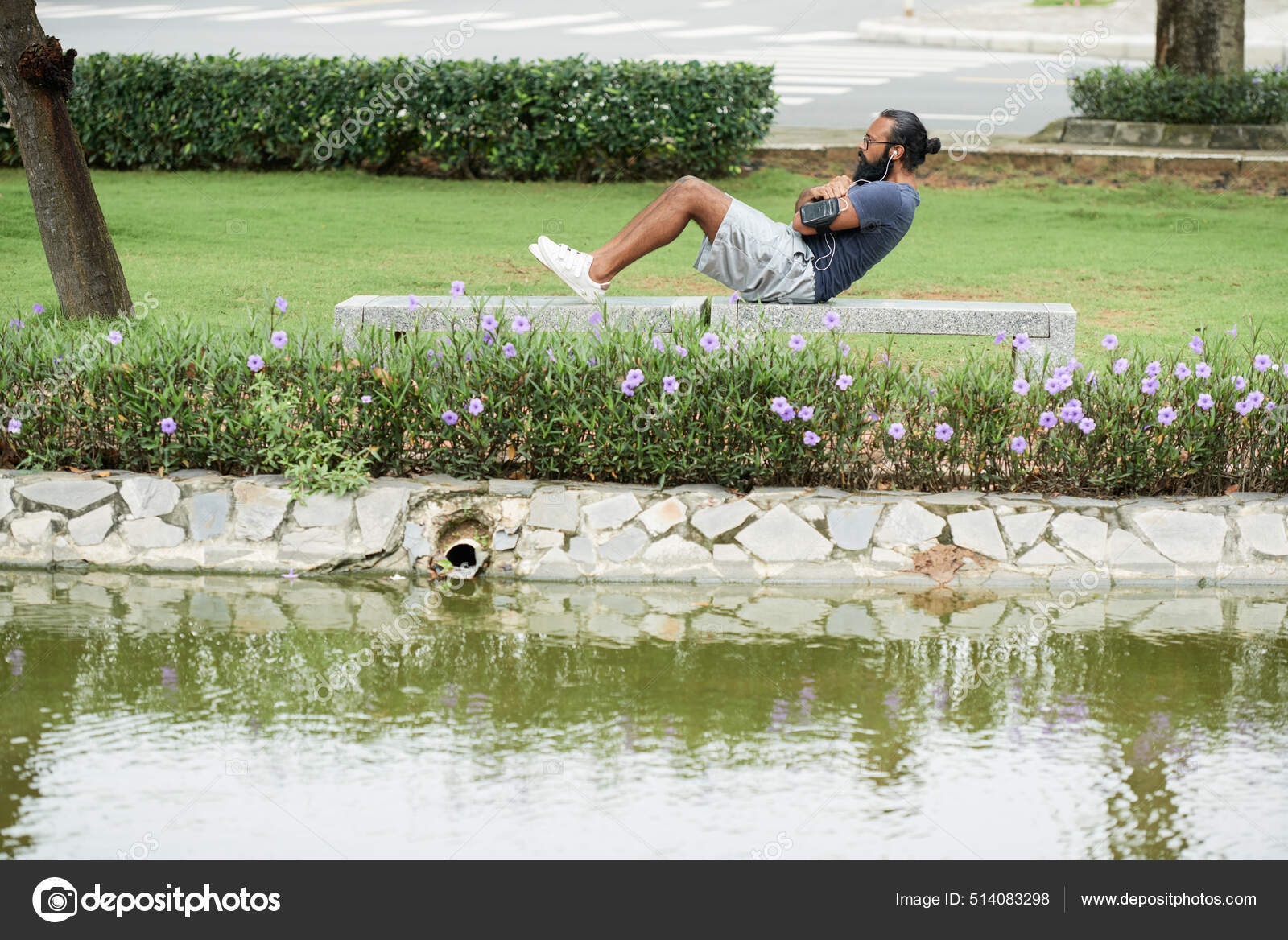 Indian Man Doing Crunches Outdoors Stock Photo by ©DragonImages 514083298