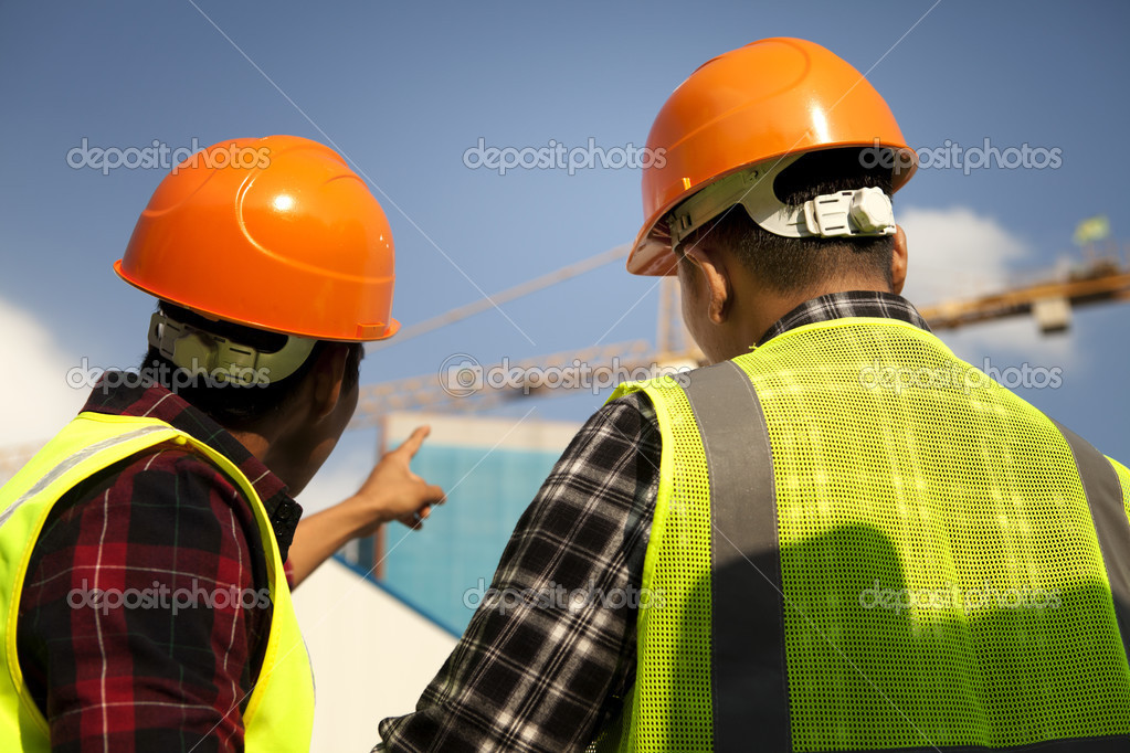 Construction worker pointing yellow crane Stock Photo by ©ndoeljindoel ...