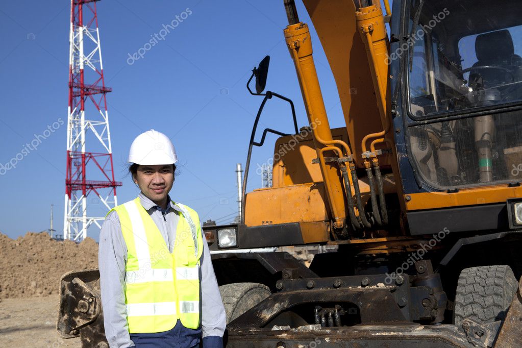 Digger standing beside excavator Stock Photo by ©ndoeljindoel 30919869