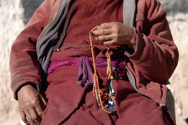 Prayer beads in monk's hand - Stock Image - Everypixel