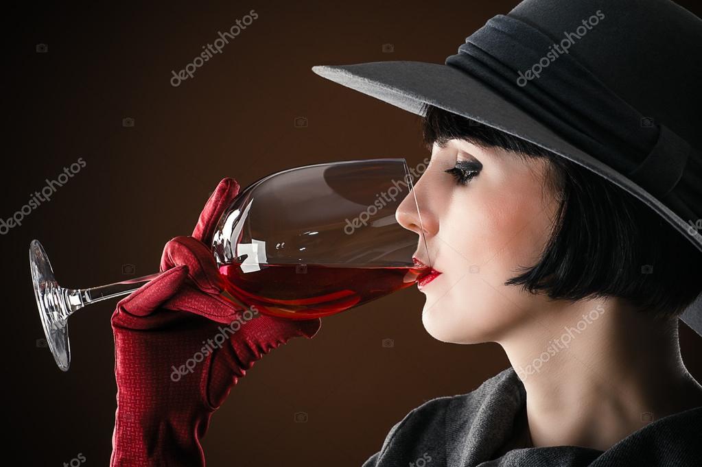 Woman in a hat drinking wine — Stock Photo © Dualshock #44618983