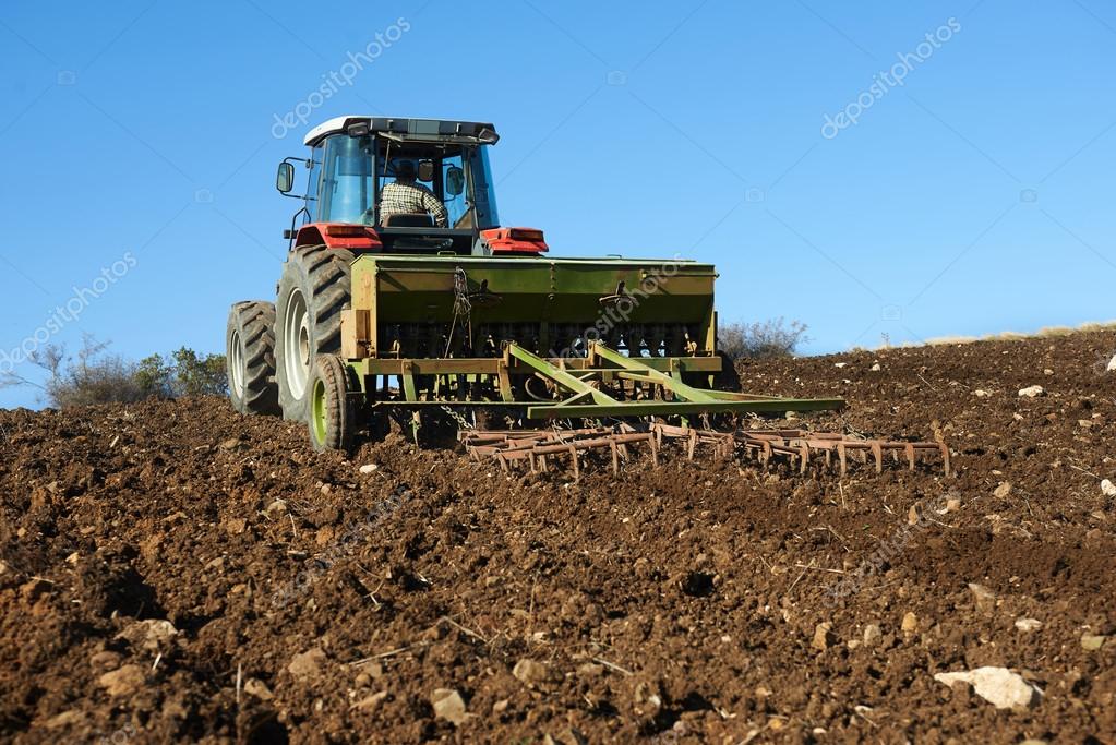 Agricultural tractor sowing seeds — Stock Photo © vkarafill #35883663