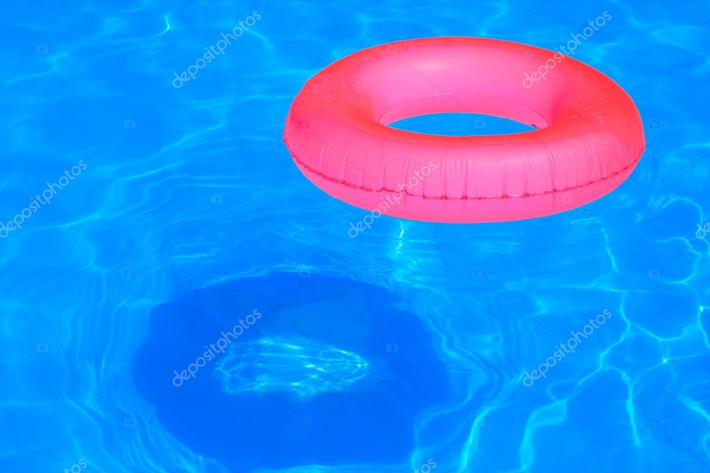 Colorful inflatable ball and round tube floating in swimming pool Stock ...