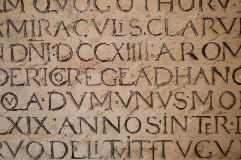 Old medieval latin inscription carved in stone — Stock Photo © gmf1000i ...