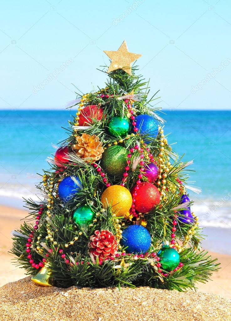 Christmas tree on the sand in the beach — Stock Photo © Nika111 #14132619