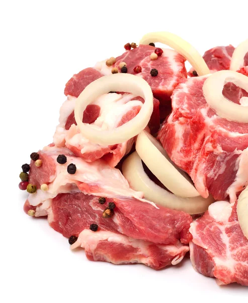 Raw meet pieces with sliced onion and black pepper - Stock Image ...