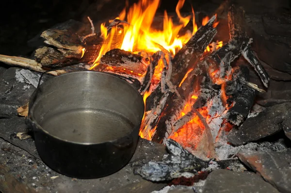 Cooking at night over campfire - Stock Image - Everypixel