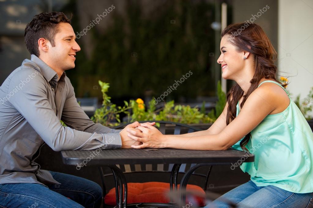 Couple holding hands across a table — Stock Photo © tonodiaz #29235113