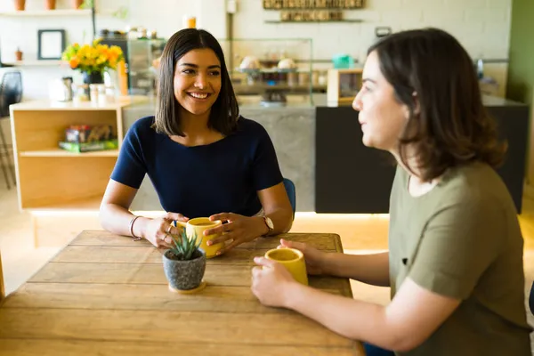 Catching up. Best friends sharing a good conversation while having a ...