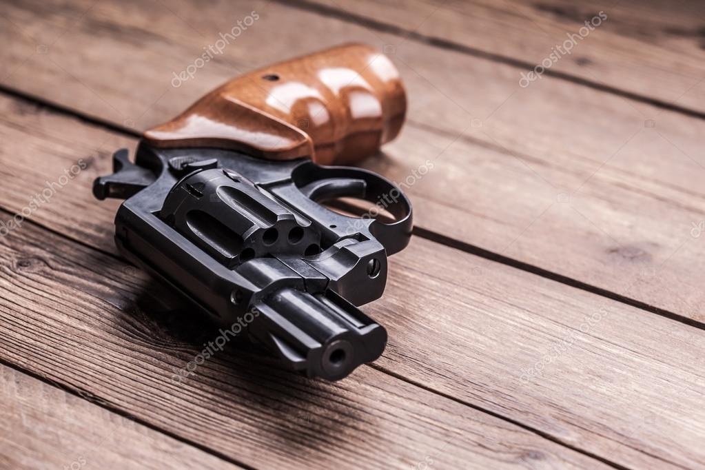 Pistol on a wood background Stock Photo by ©merrydolla 32459973