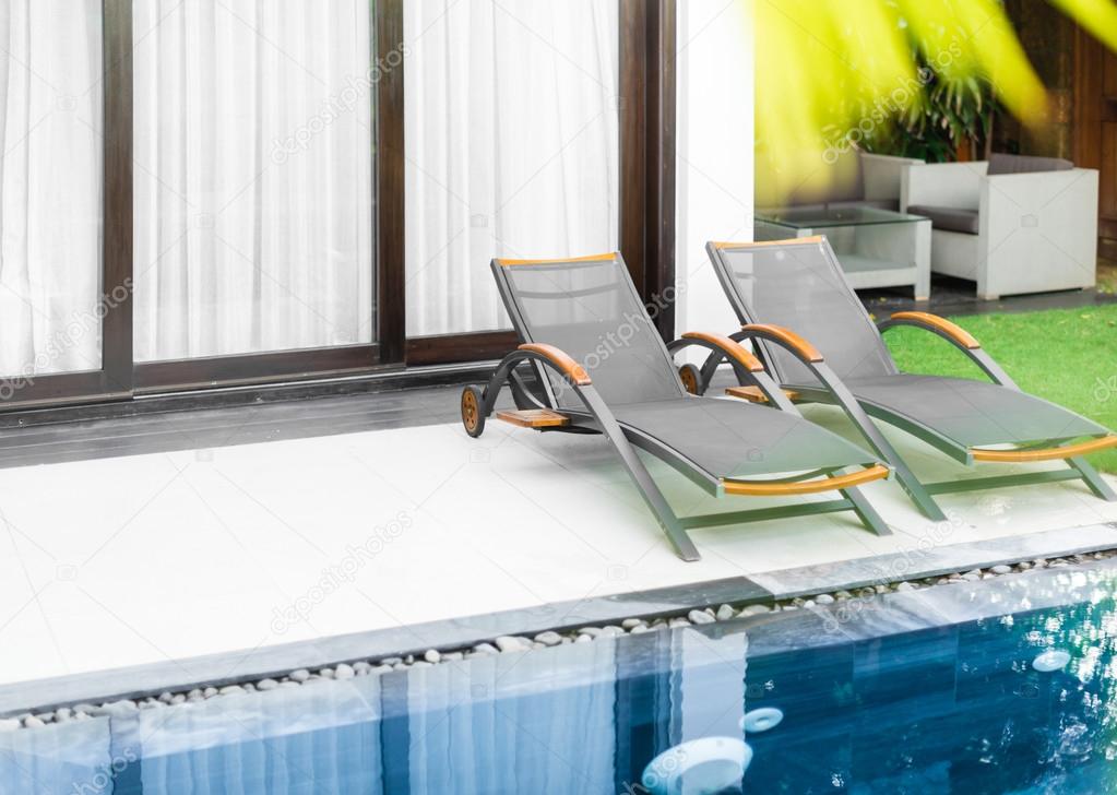 Luxury hotel room with pool, lawn and two sunbeds. — Stock Photo ...