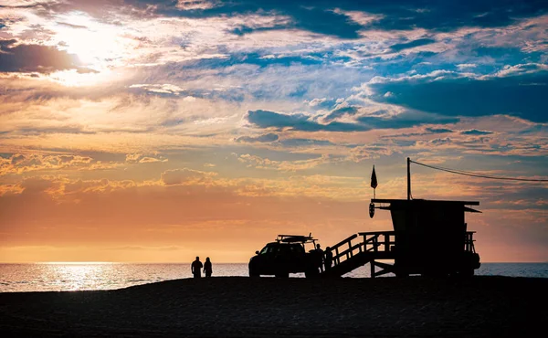Lifeguard crew watching ocean at sunset in Santa Monica, California ...