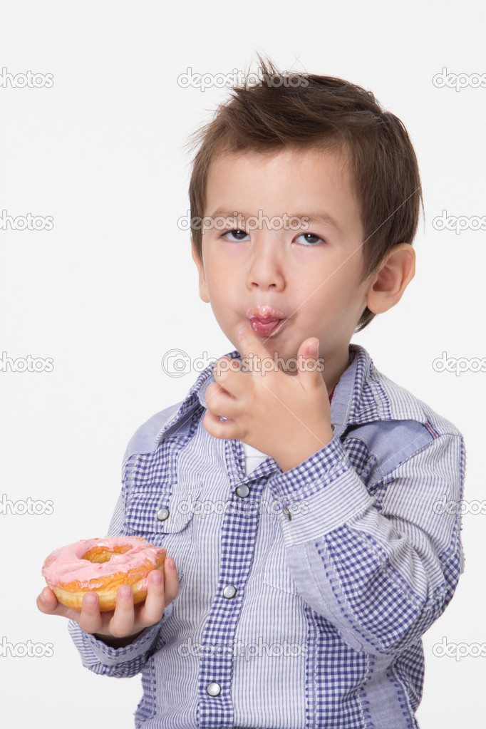 Boy eating a donut — Stock Photo © tiverylucky #28138383