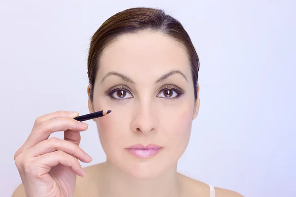 Woman applying concealer Stock Photos, Royalty Free Woman applying ...