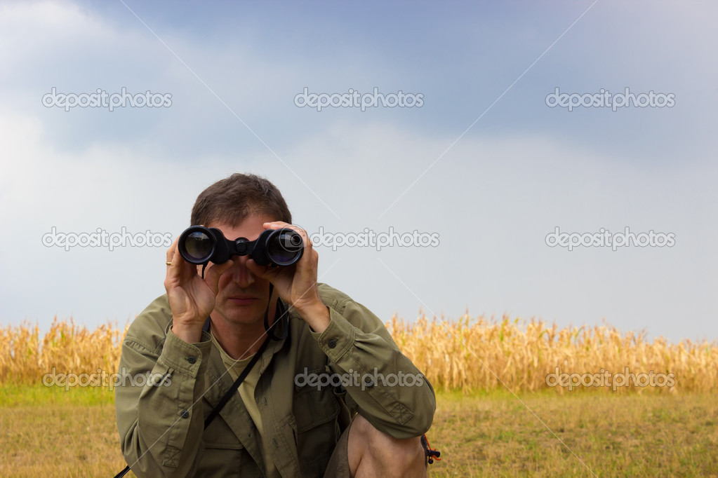 Man with binoculars Stock Photo by ©overcrew 31025483