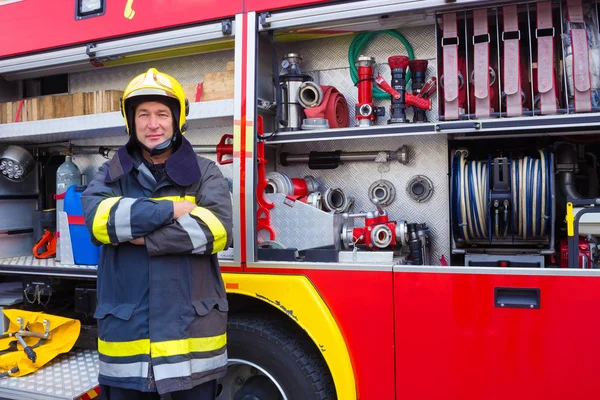 Image of smiling fireman sitting in fire truck at fire station Stock ...