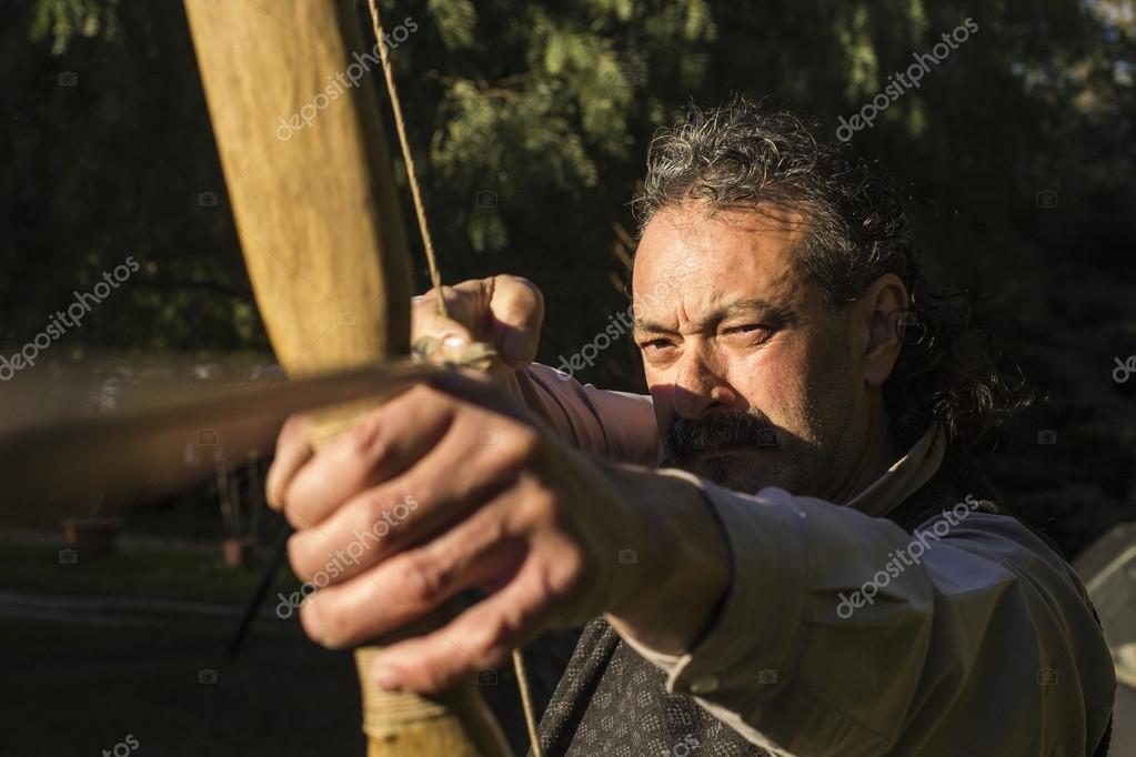 Senior Archer with Antique Bow Aiming — Stock Photo © BenjaminSilva ...