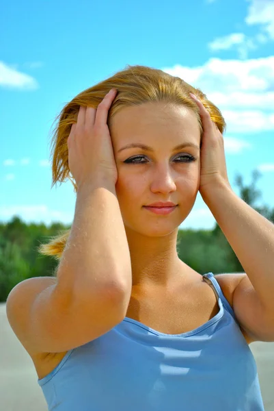 Very Beautiful Female Model Poses And Touches Her Hair Stock Image