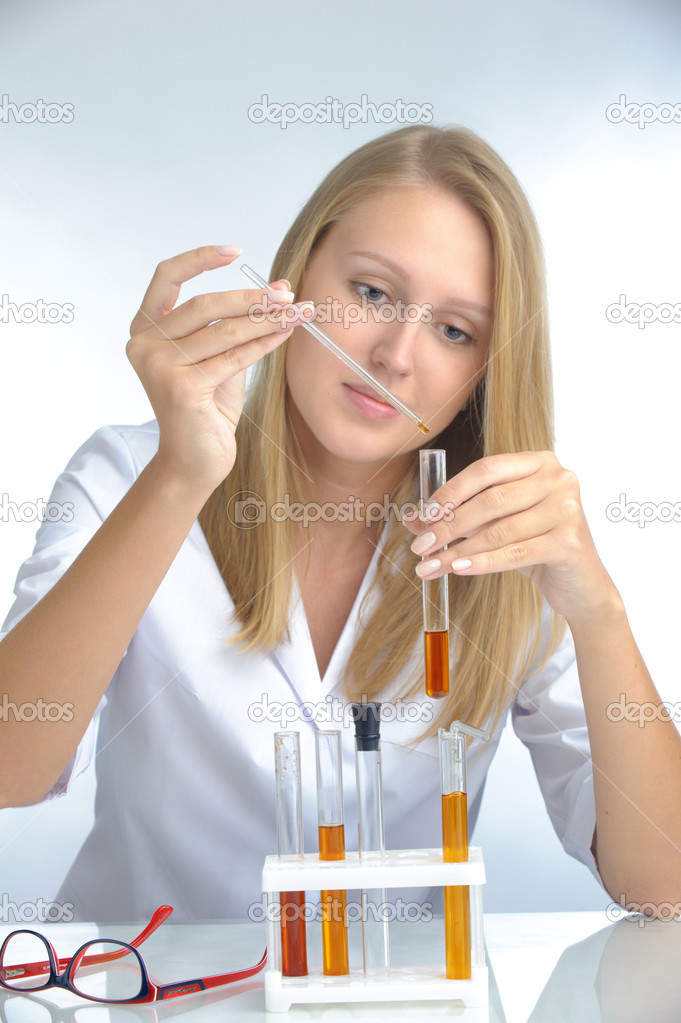 Young beautiful female scientist with flasks — Stock Photo © toloubaev ...