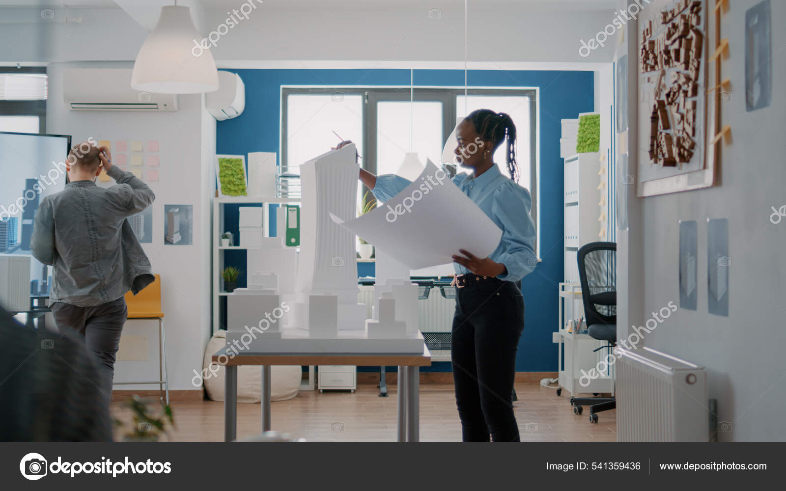 Woman constructor designing building model with architectural ...