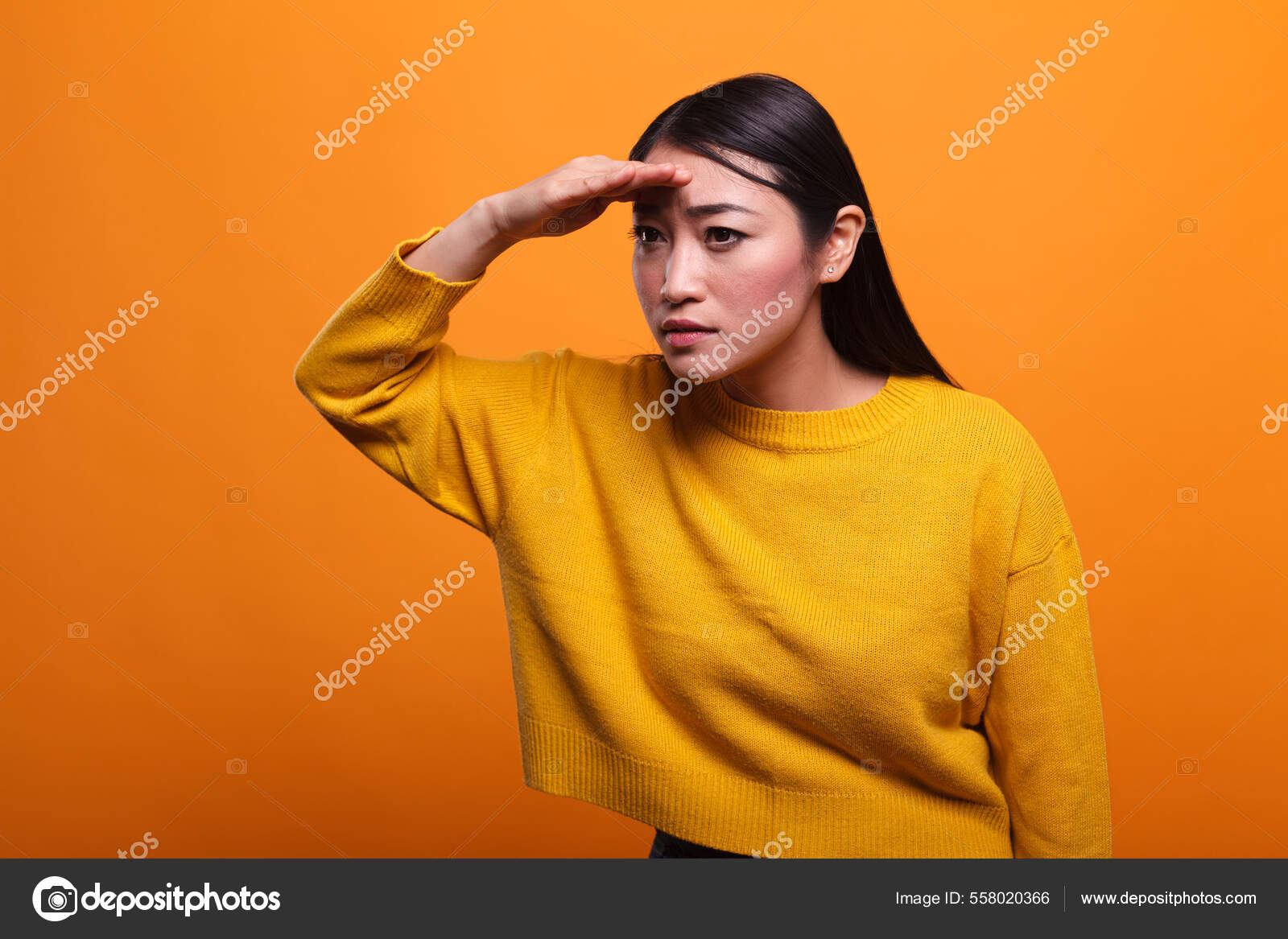 Curious intrigued asian woman holding hand above eyes and peering into ...