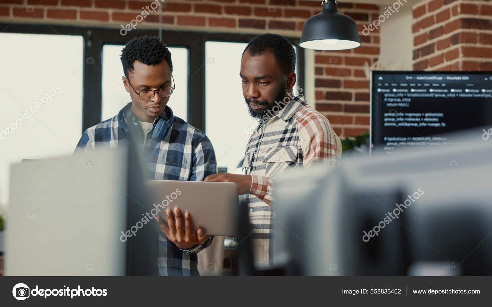 Coders Talking About Algorithms Holding Laptop Pointing At Sorce Code