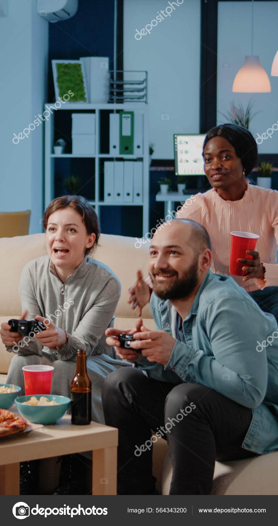 Coworkers playing video games with controllers on console — Stock Photo ...