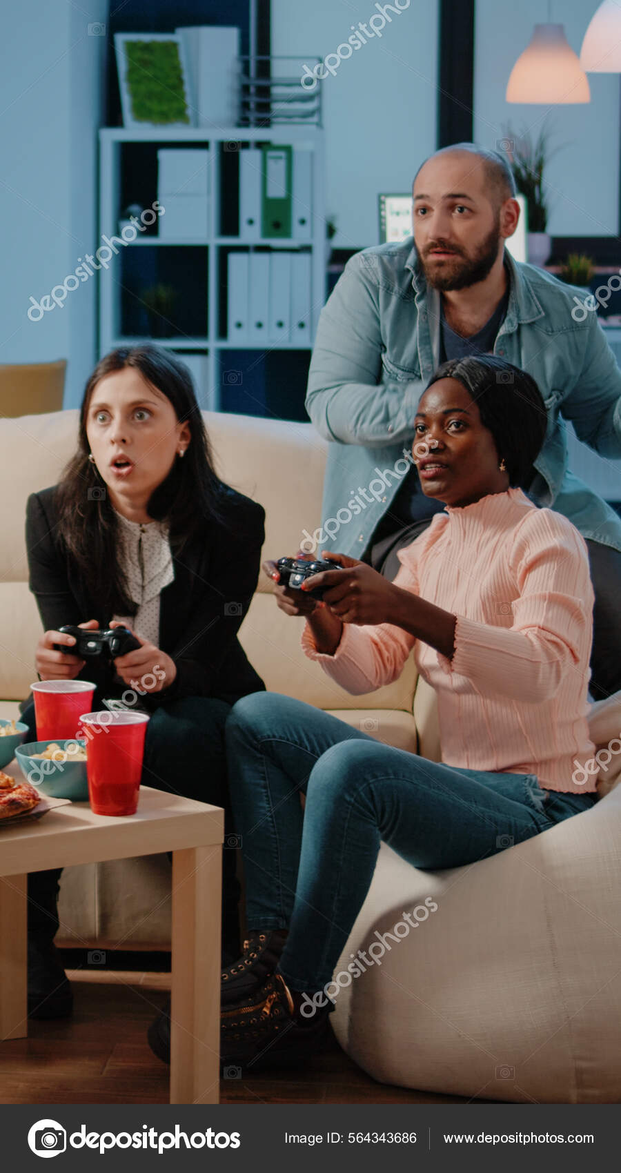 Happy colleagues playing video games on console television — Stock ...